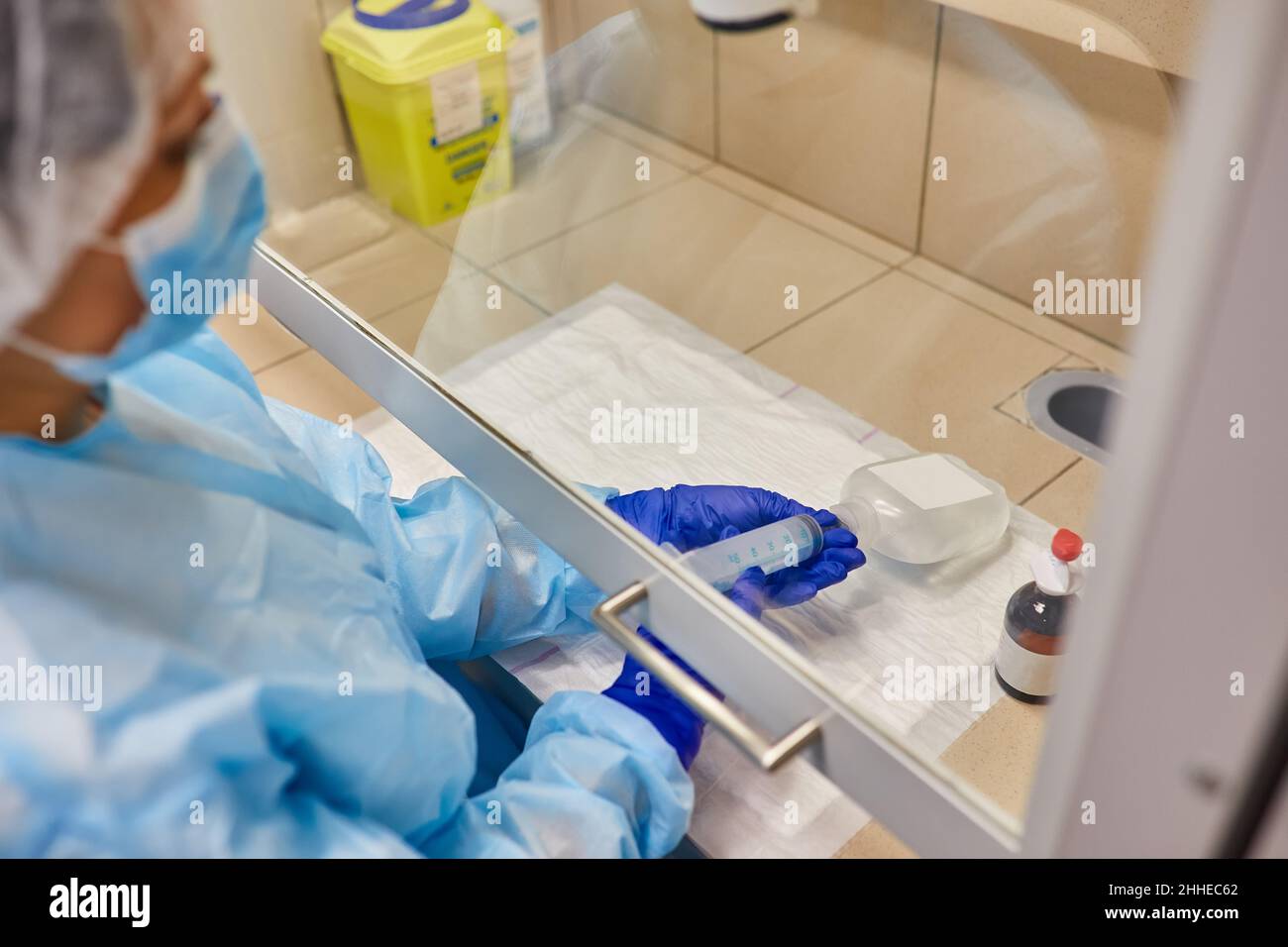 Anesthesiologist Doctors hand inject syringe into mixing normal saline ...