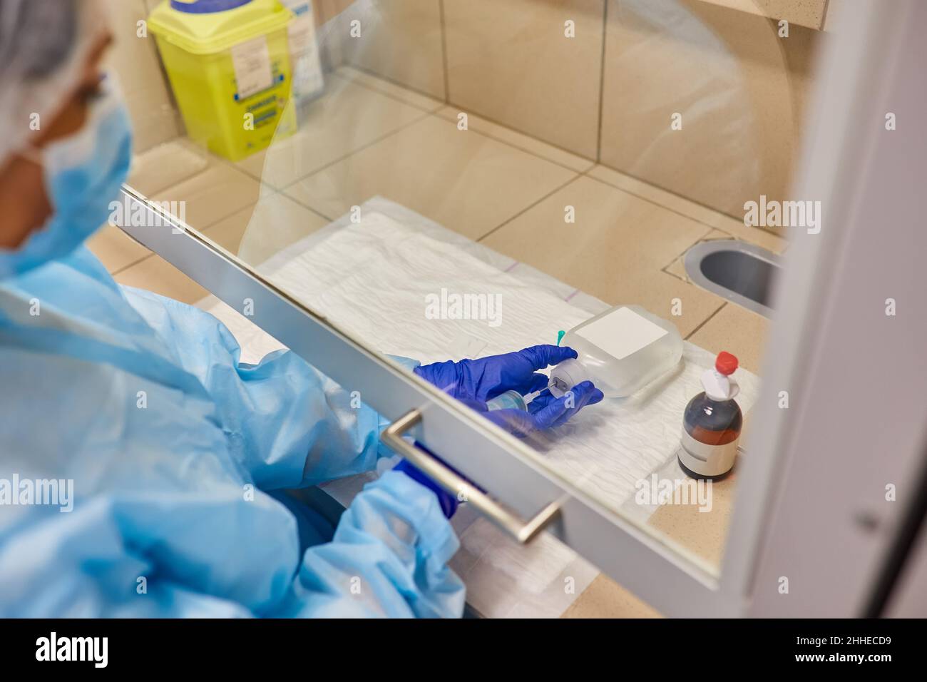 Anesthesiologist Doctors hand inject syringe into mixing normal saline ...