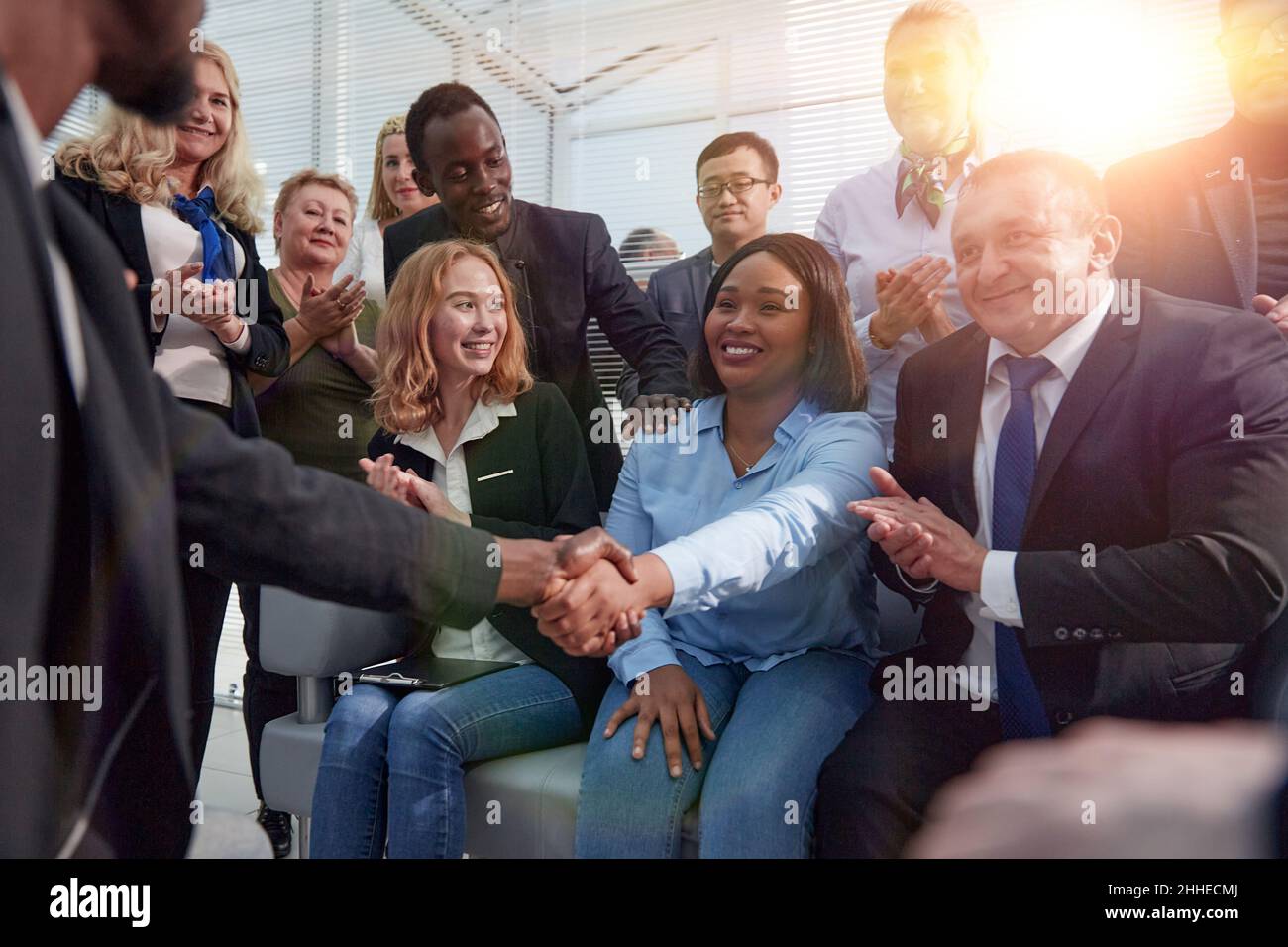 employees shaking hands at a corporate meeting Stock Photo - Alamy