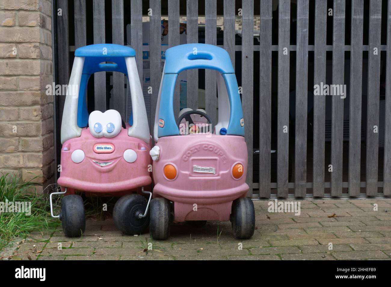 Plastic pedal cars left outside trumpington town house with blue ...