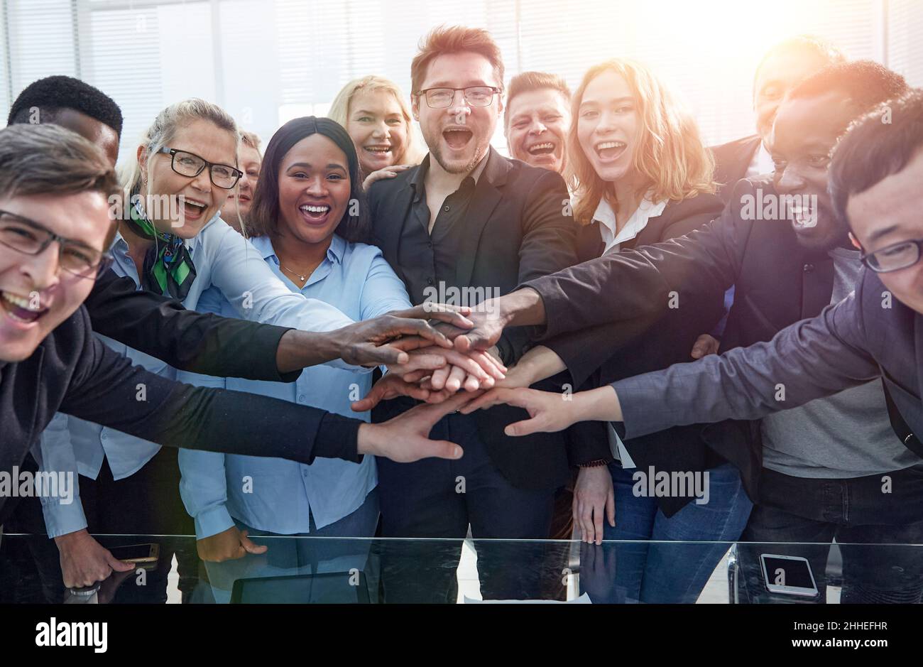 Business team stacking their hands together Stock Photo - Alamy