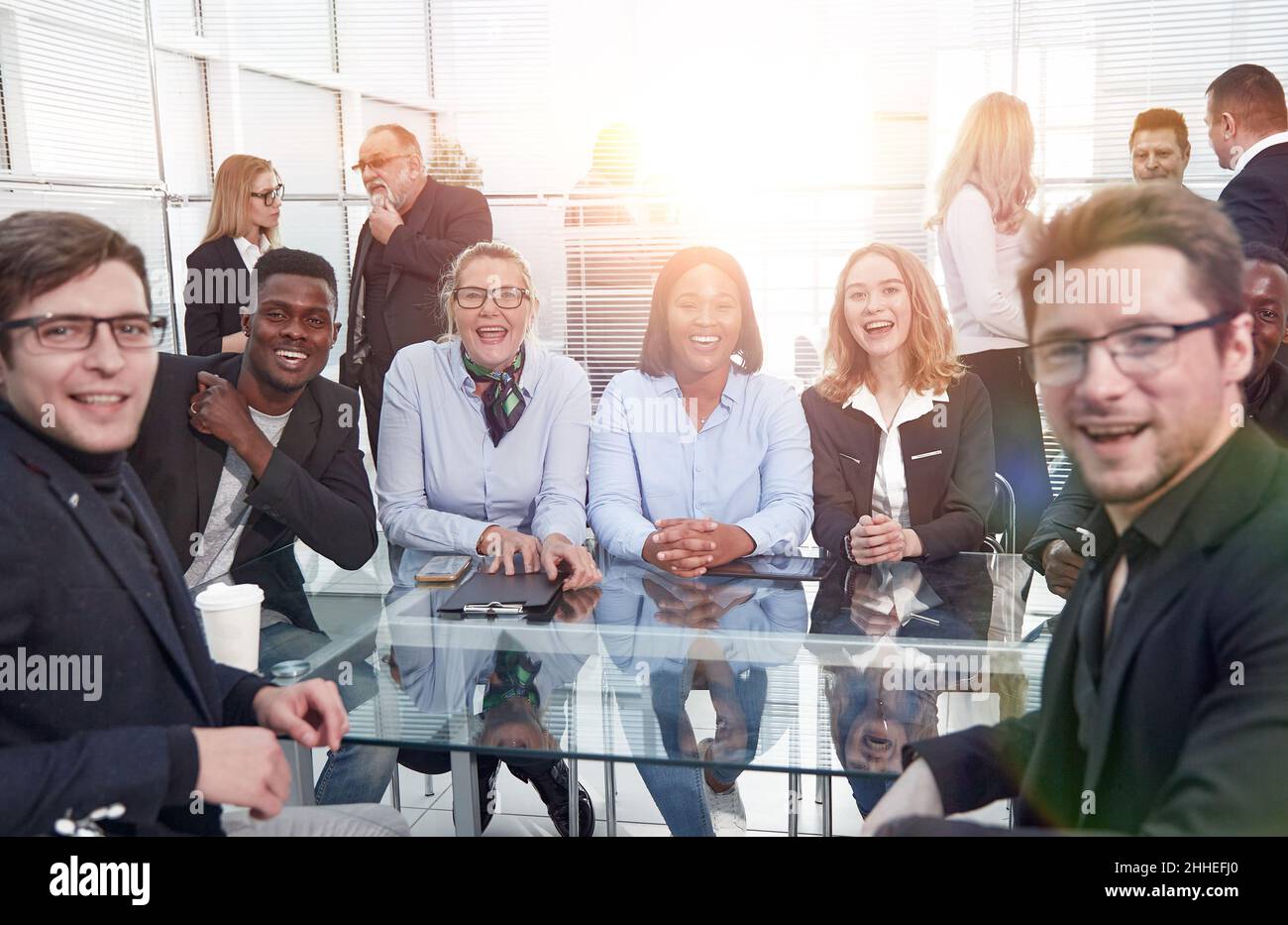 Group Of Businesspeople Meeting Around Table In Office Stock Photo - Alamy