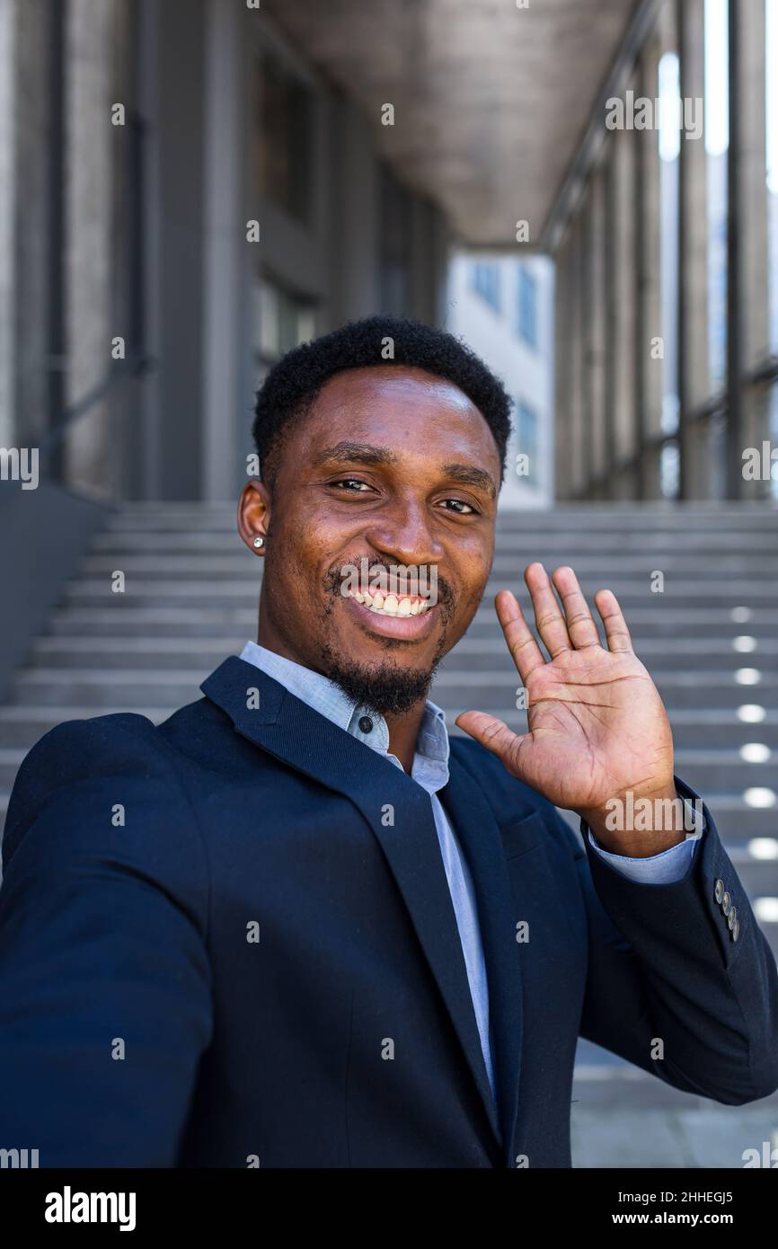 vertical view smartphone camera African American businessman speaks on ...