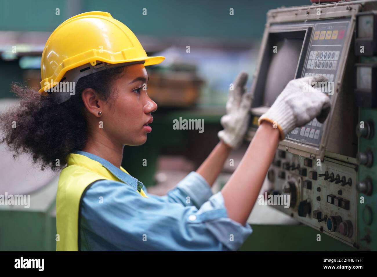 Female apprentice in metal working factory, Portrait of working female ...