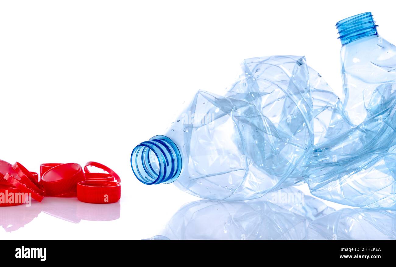 Crushed plastic bottles with caps, isolated on white Stock Photo - Alamy