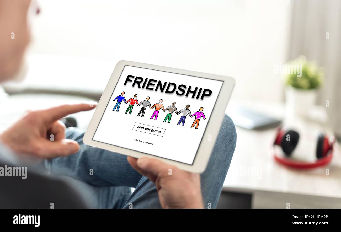 Tablet screen displaying a friendship concept Stock Photo - Alamy