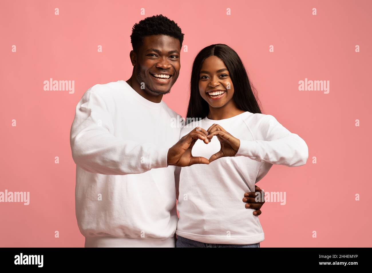 Beautiful loving african american couple showing love gesture Stock ...
