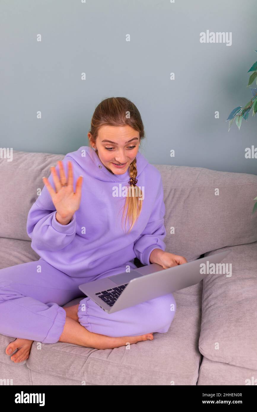 Happy smiling teenage girl student watching learning online video zoom ...