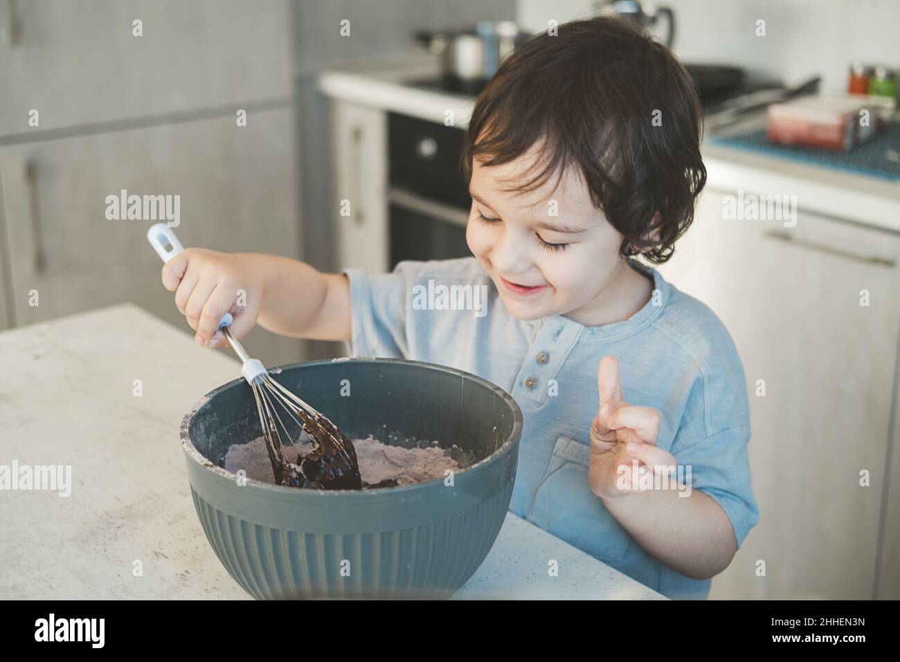 A little boy is cooking in the kitchen Stock Photo - Alamy