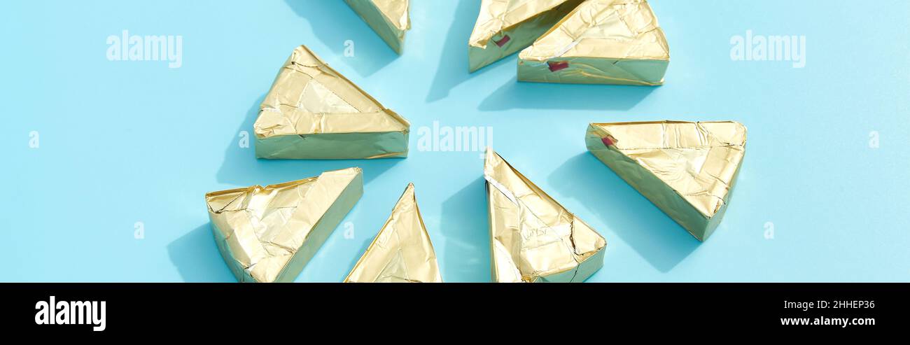 Processed cheese on blue background with deep long shadows. Minimal ...