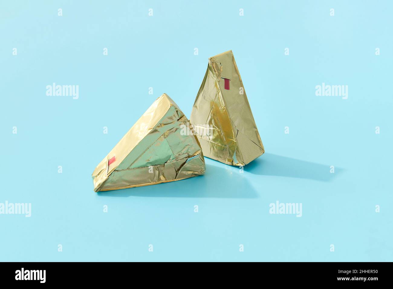 Processed cheese on blue background with deep long shadows. Minimal ...