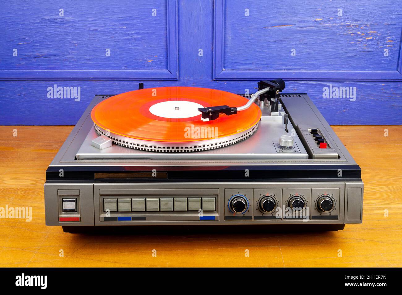 Vintage turntable vinyl record player with red vinyl on a table Stock ...