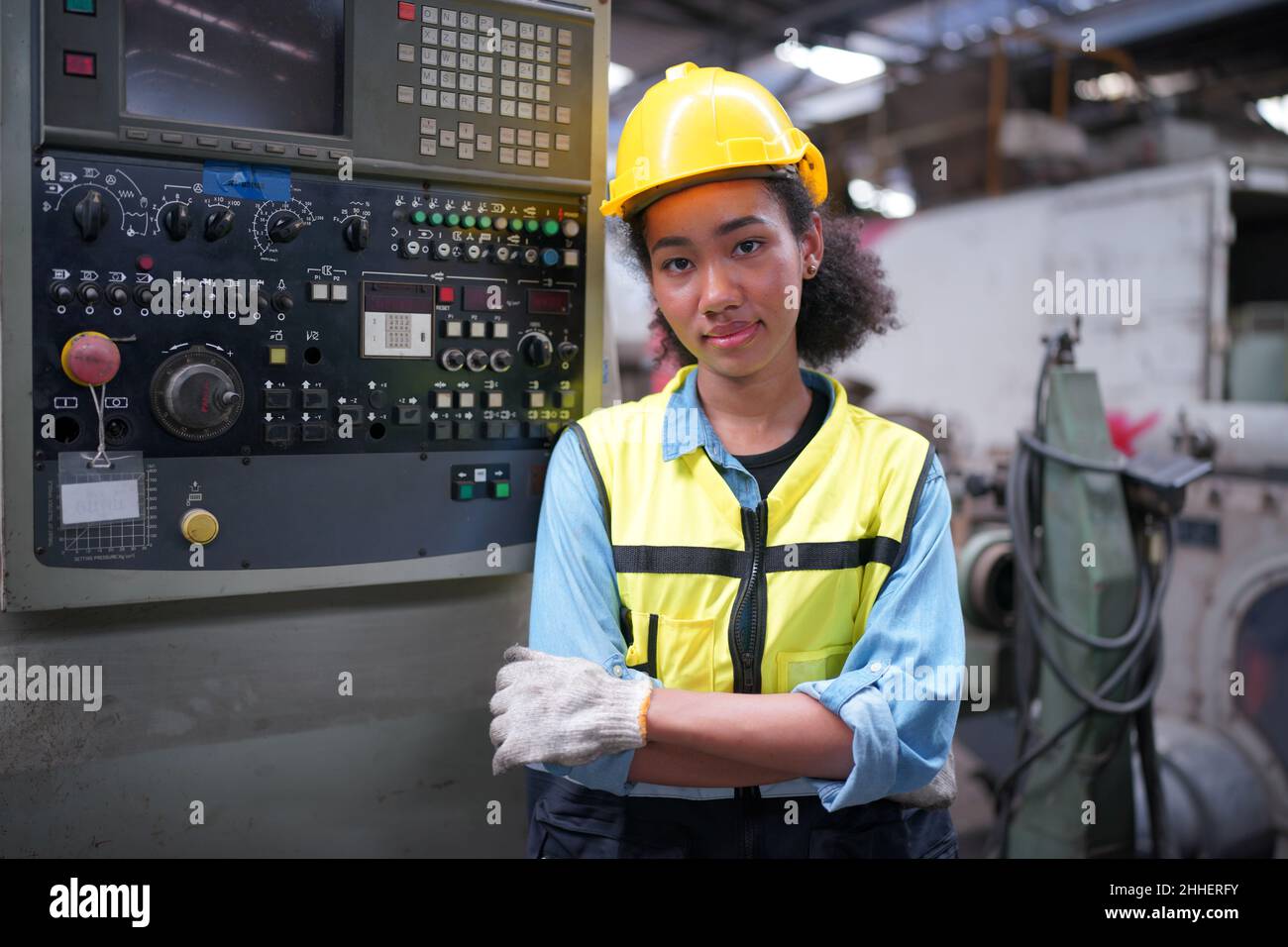 Female apprentice in metal working factory, Portrait of working female ...