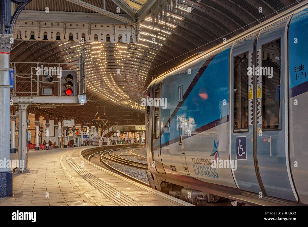 A railway station concourse with a train alongside.. An 19h century ...
