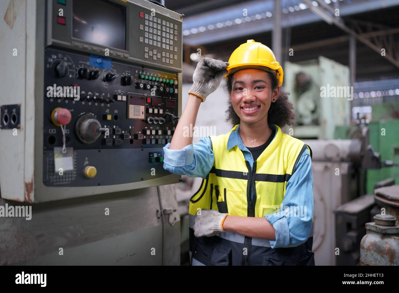Female apprentice in metal working factory, Portrait of working female ...