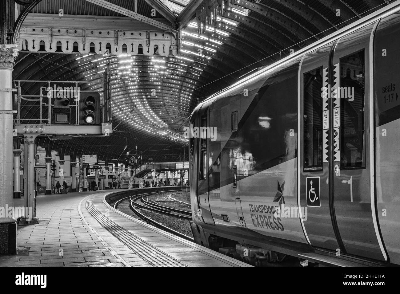 A railway station concourse with a train alongside.. An 19h century ...