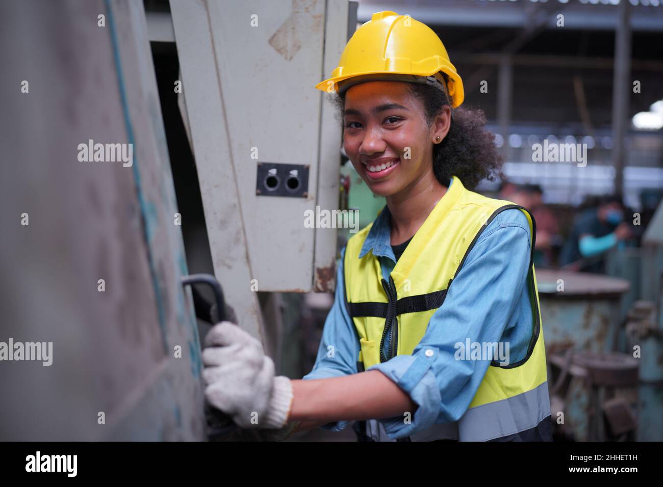Female apprentice in metal working factory, Portrait of working female ...