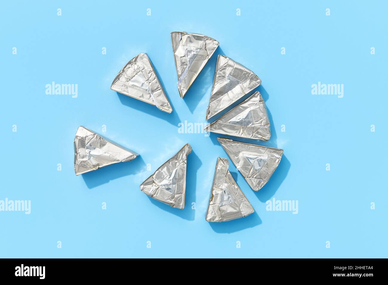 Processed cheese on blue background with deep long shadows. Minimal ...