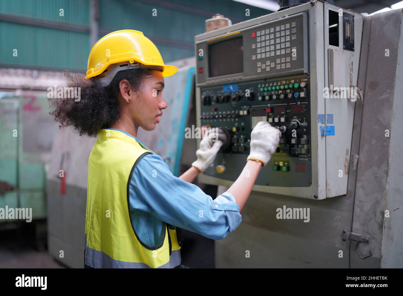 Female apprentice in metal working factory, Portrait of working female ...