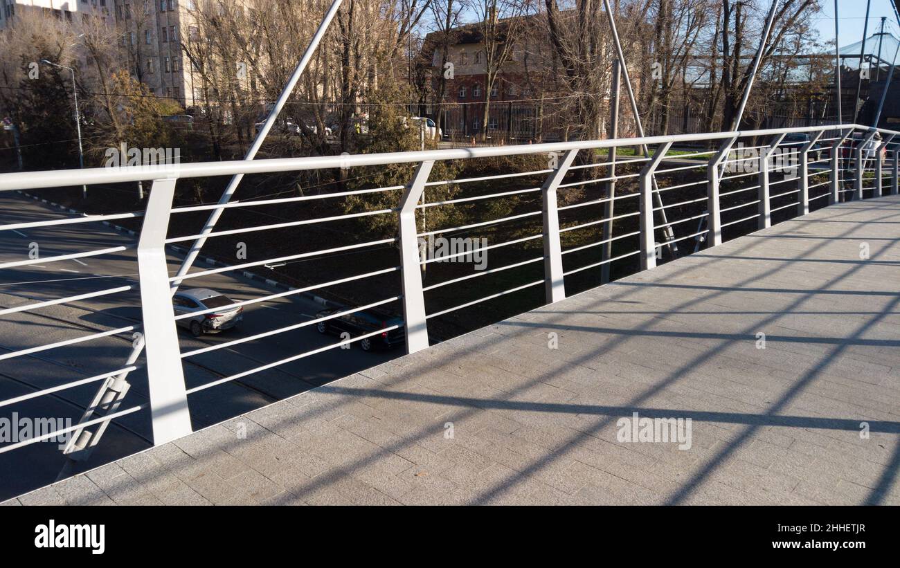 New pedestrian bridge with metal railings. Empty footbridge across the ...