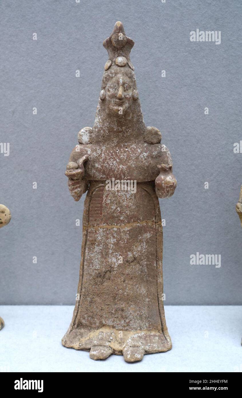 Standing goddes with crown (polos), holding a pomegranate and blossom ...