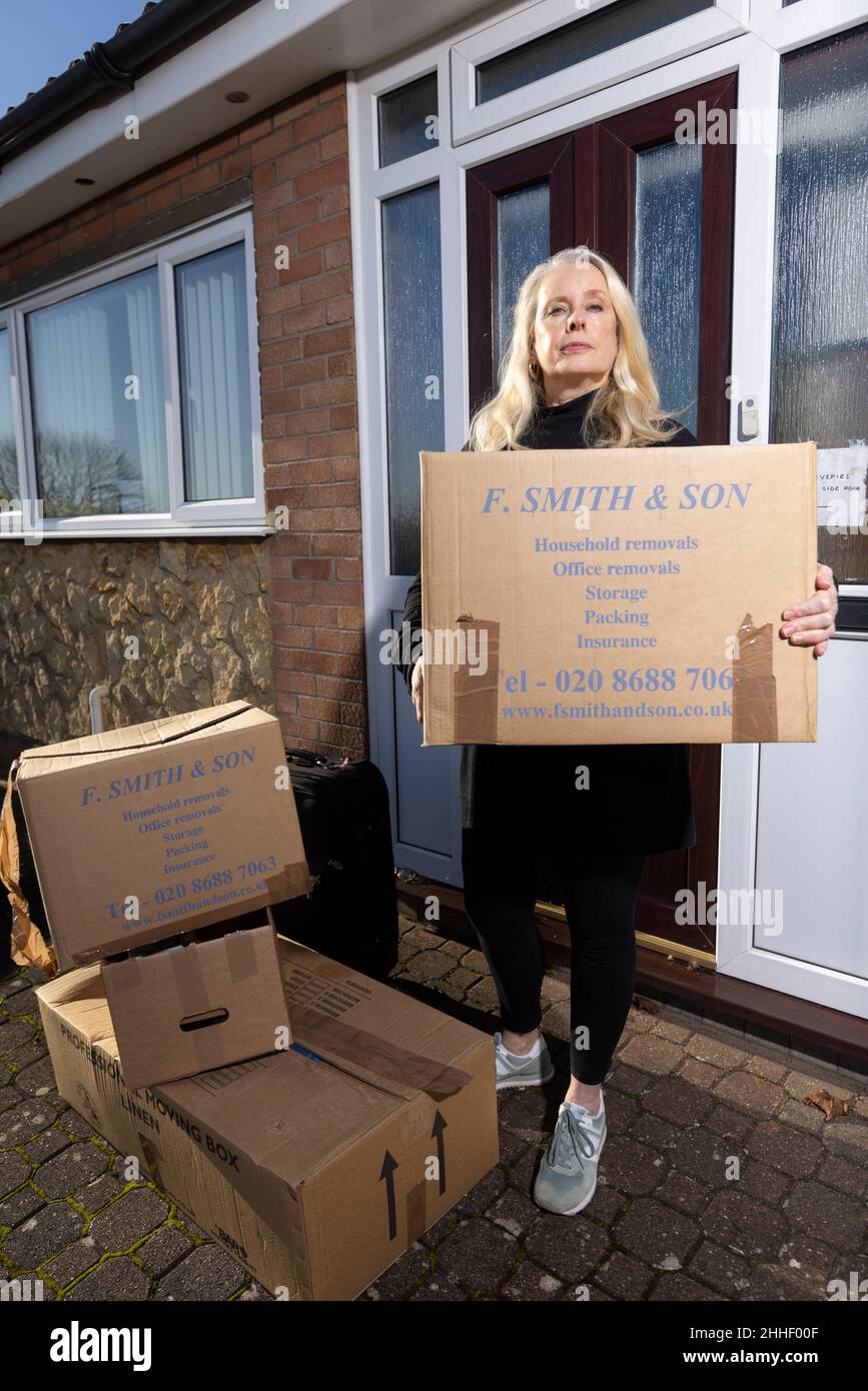 Senior lady with some of her belongings before moving home, England ...