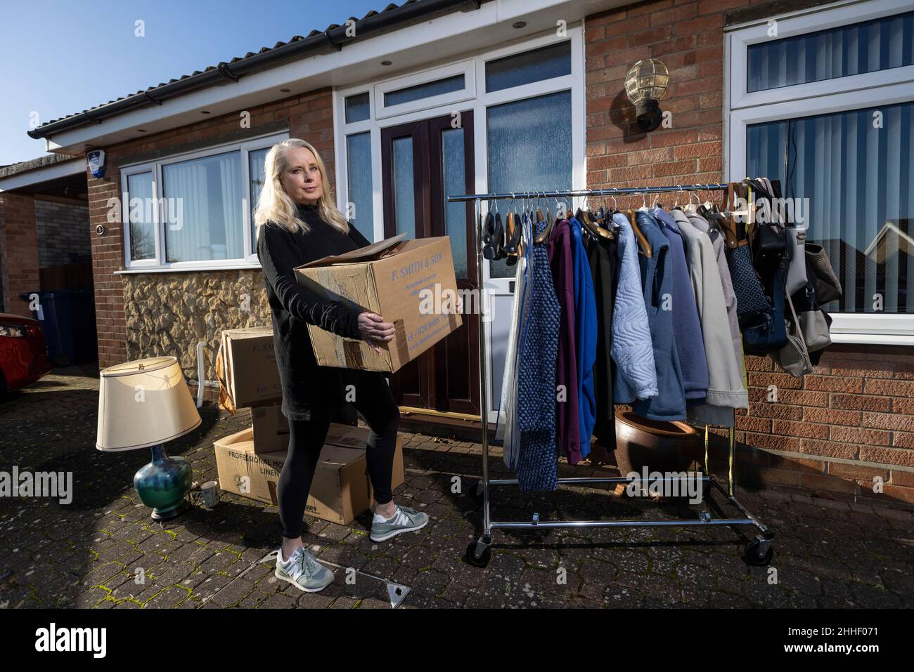 Senior lady with some of her belongings before moving home, England ...