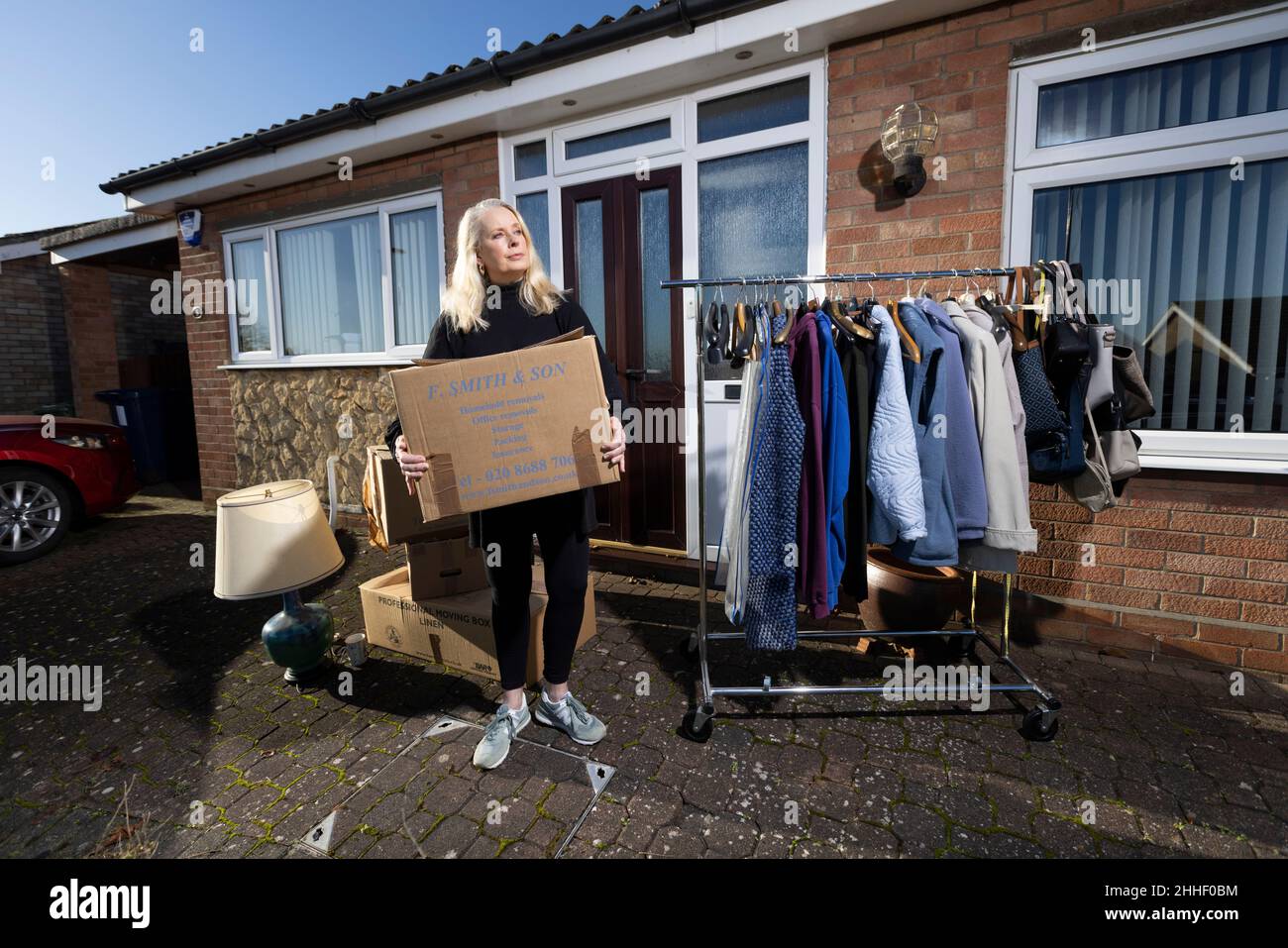 Senior lady with some of her belongings before moving home, England ...
