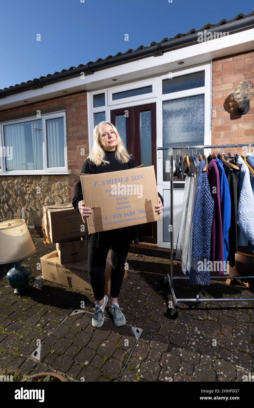 Senior lady with some of her belongings before moving home, England ...