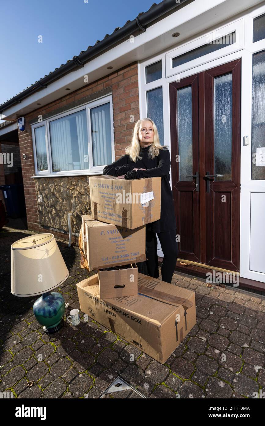 Senior lady with some of her belongings before moving home, England ...