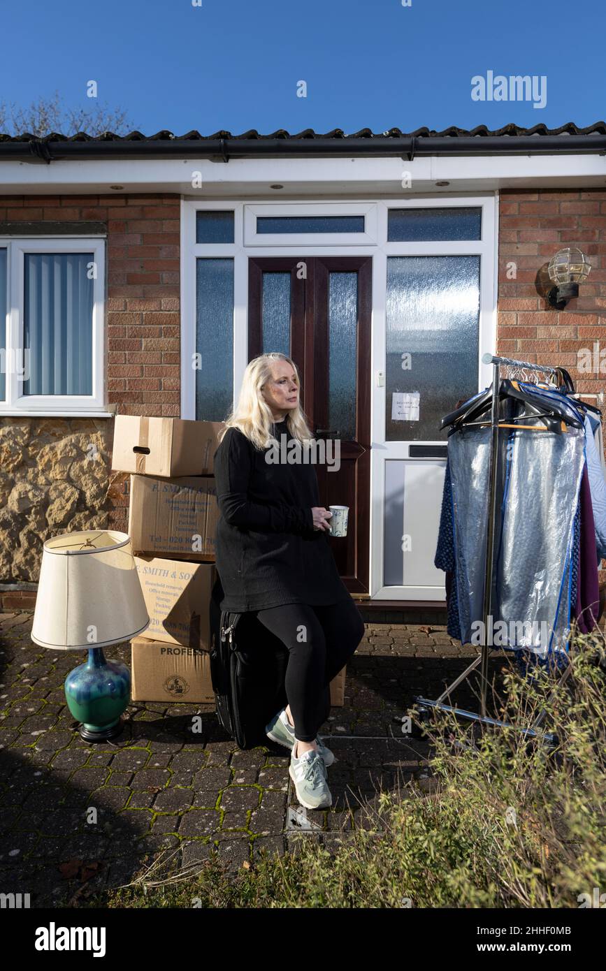 Senior lady with some of her belongings before moving home, England ...