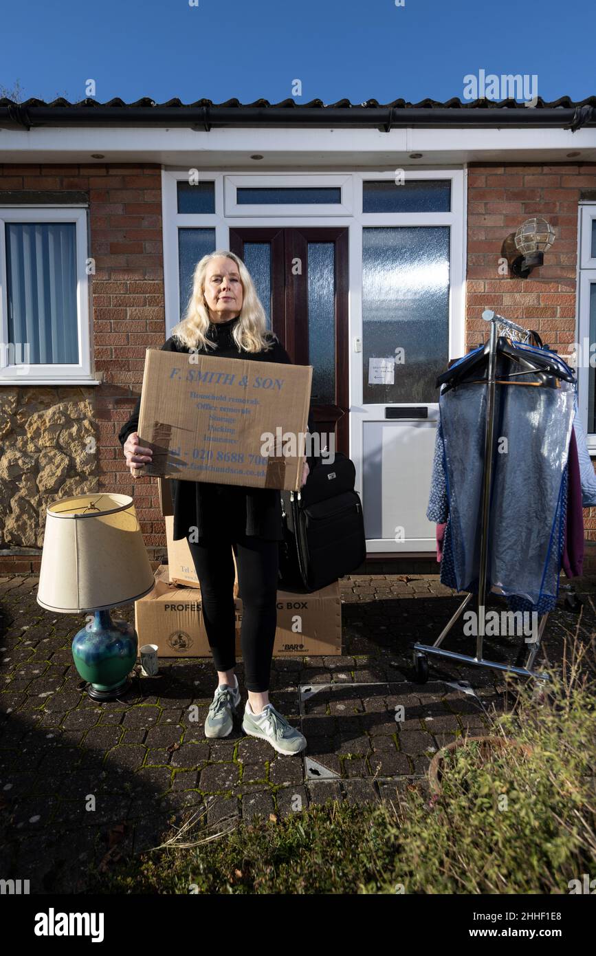 Senior lady with some of her belongings before moving home, England ...