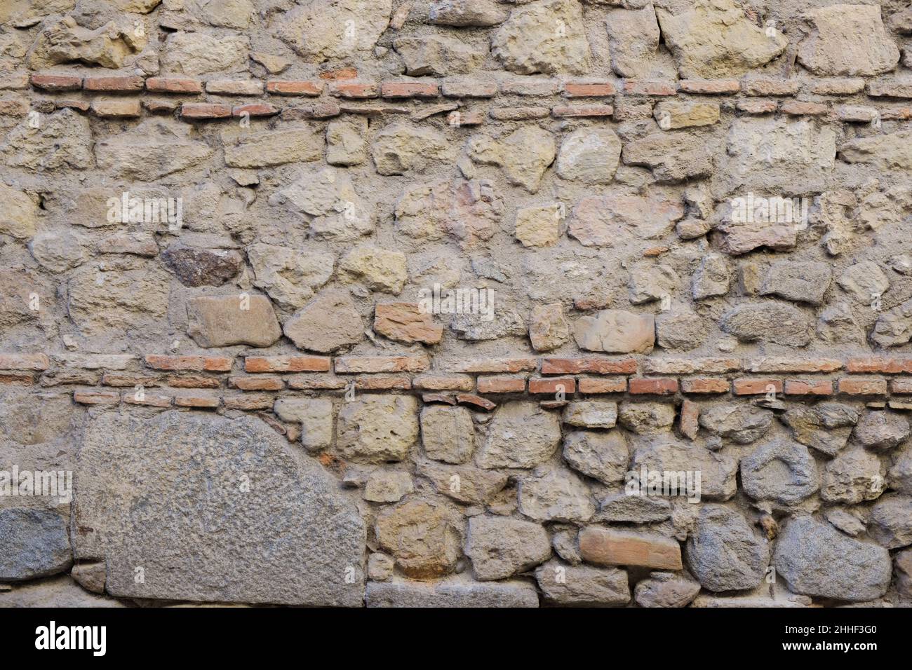 wall background with lines of bricks and stone blocks. Rustic texture ...