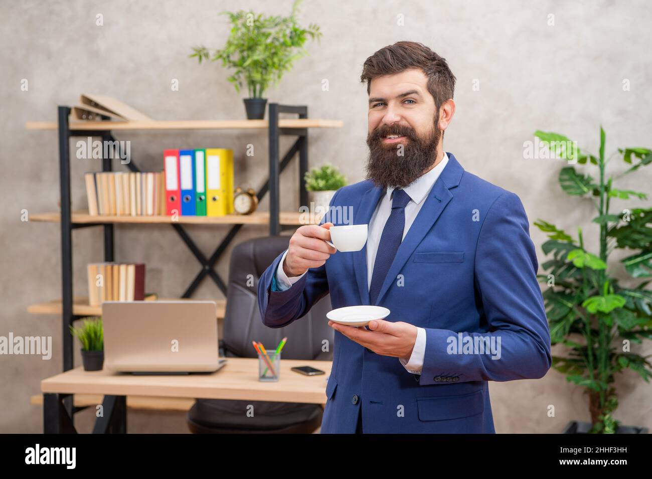 happy brutal ceo in businesslike suit has lunch break with coffee cup ...