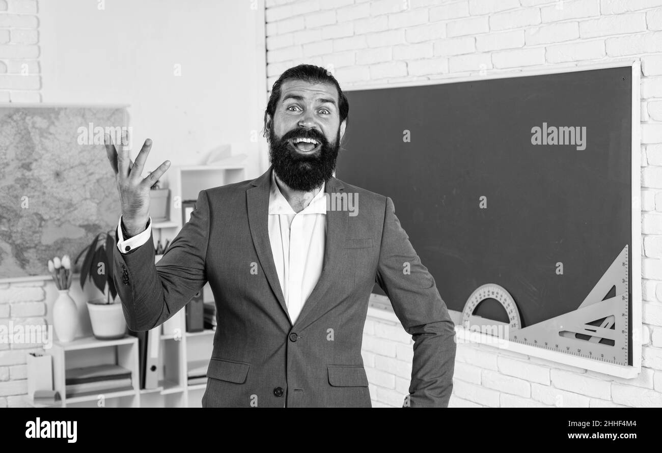 he is speaking. informal education. male student in school classroom ...