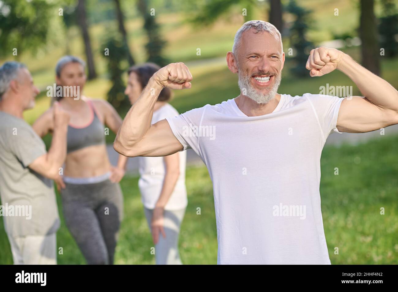 A gray-haired bearded mid aged man feeling positive and happy Stock Photo - Alamy