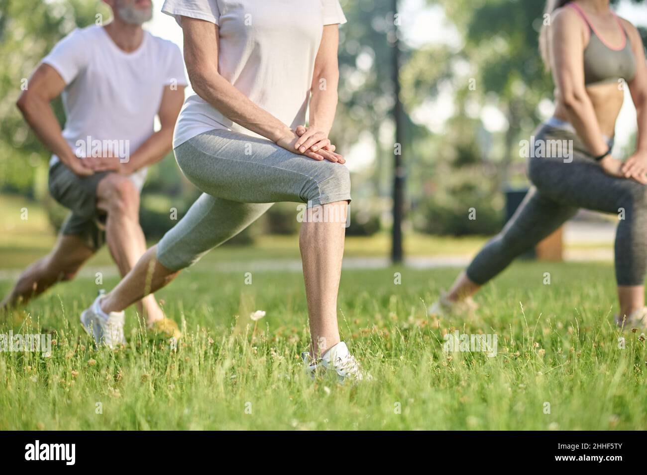 Group of people having a workout and doing lunges together Stock Photo ...
