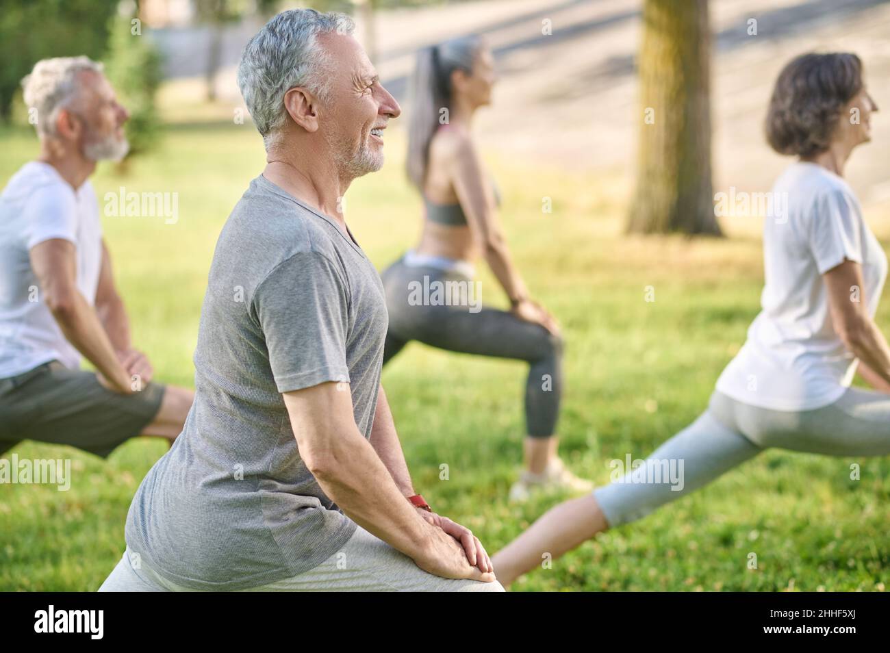 Group of mid aged people having a workout in the park Stock Photo - Alamy
