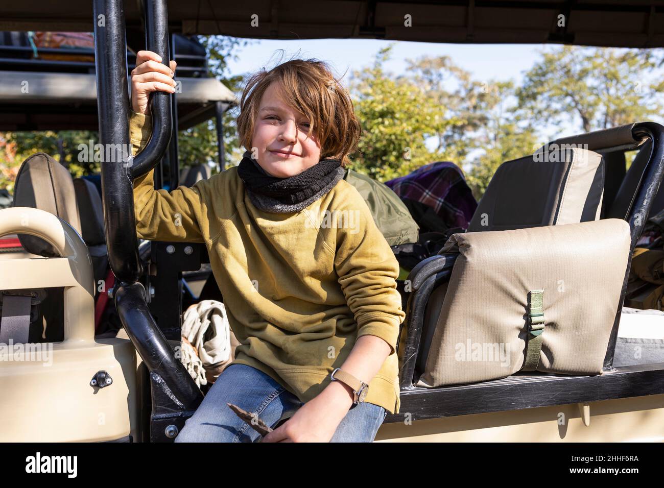 A boy seated in a jeep, smiling, looking at the camera Stock Photo - Alamy