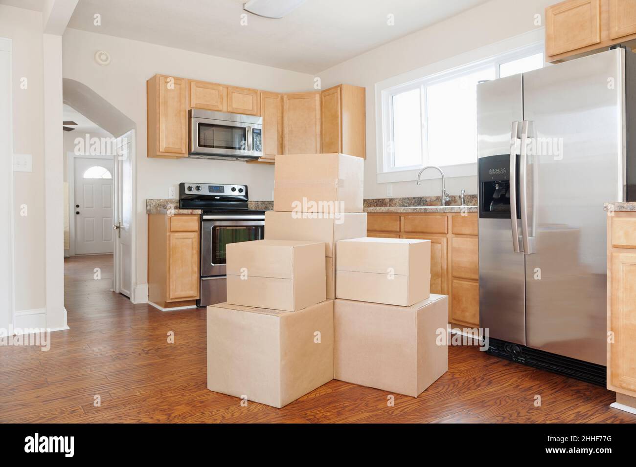 Moving house, relocation, cardboard boxes piled up in a house fitted ...