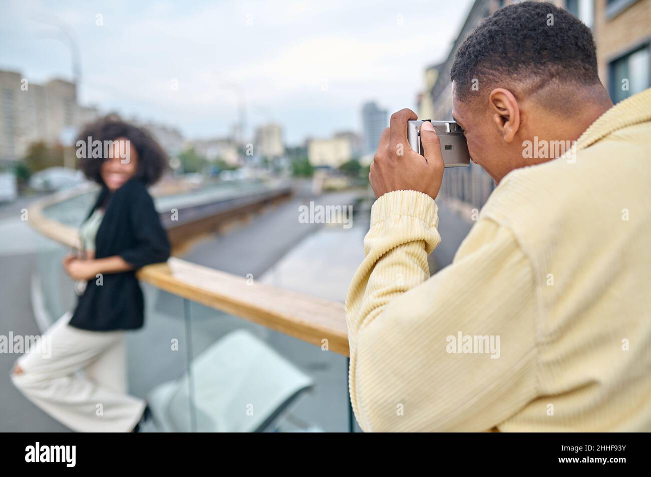 Man with his back to camera photographing woman Stock Photo - Alamy