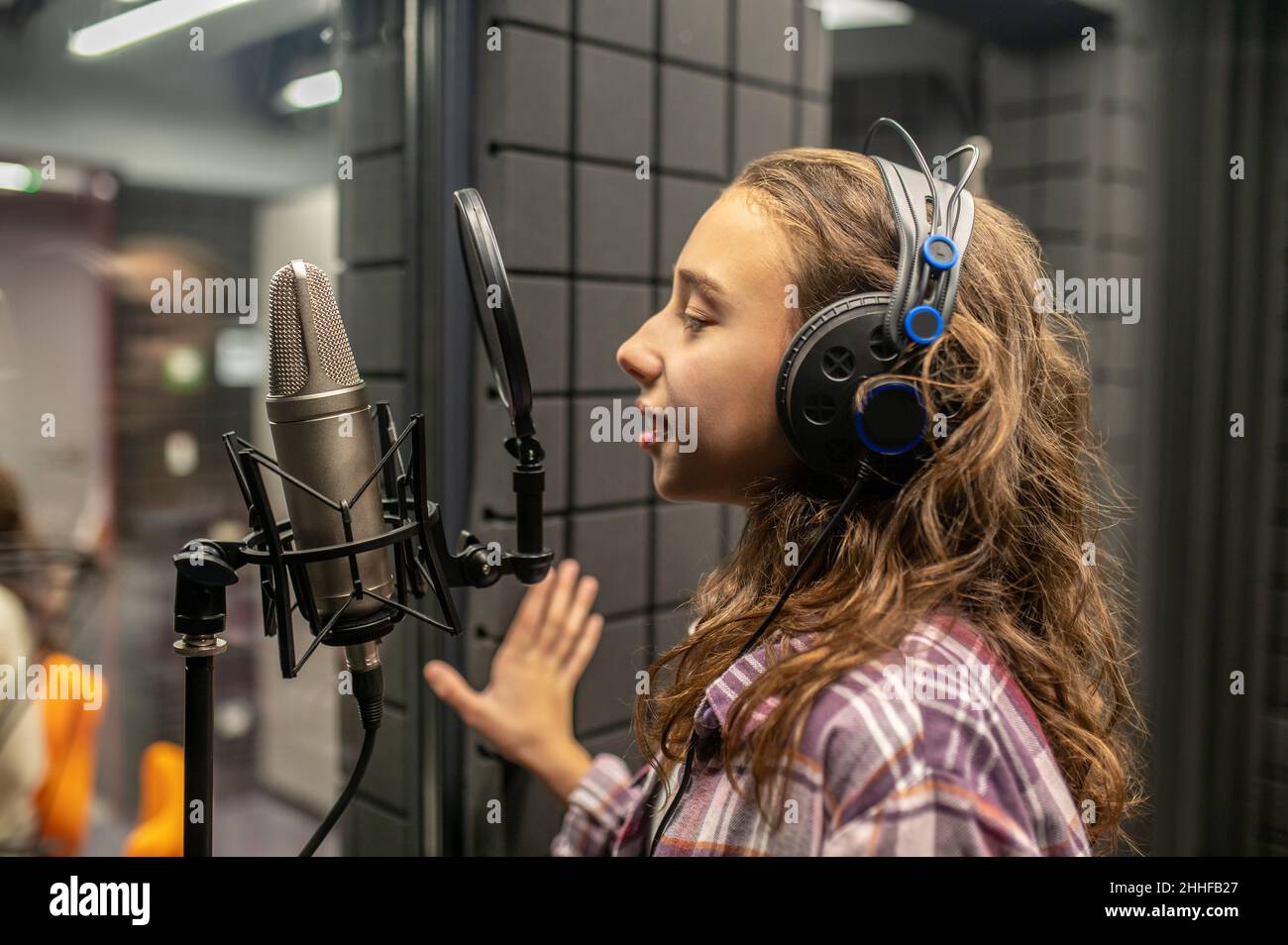 Calm singer performing a song in the recording studio Stock Photo - Alamy