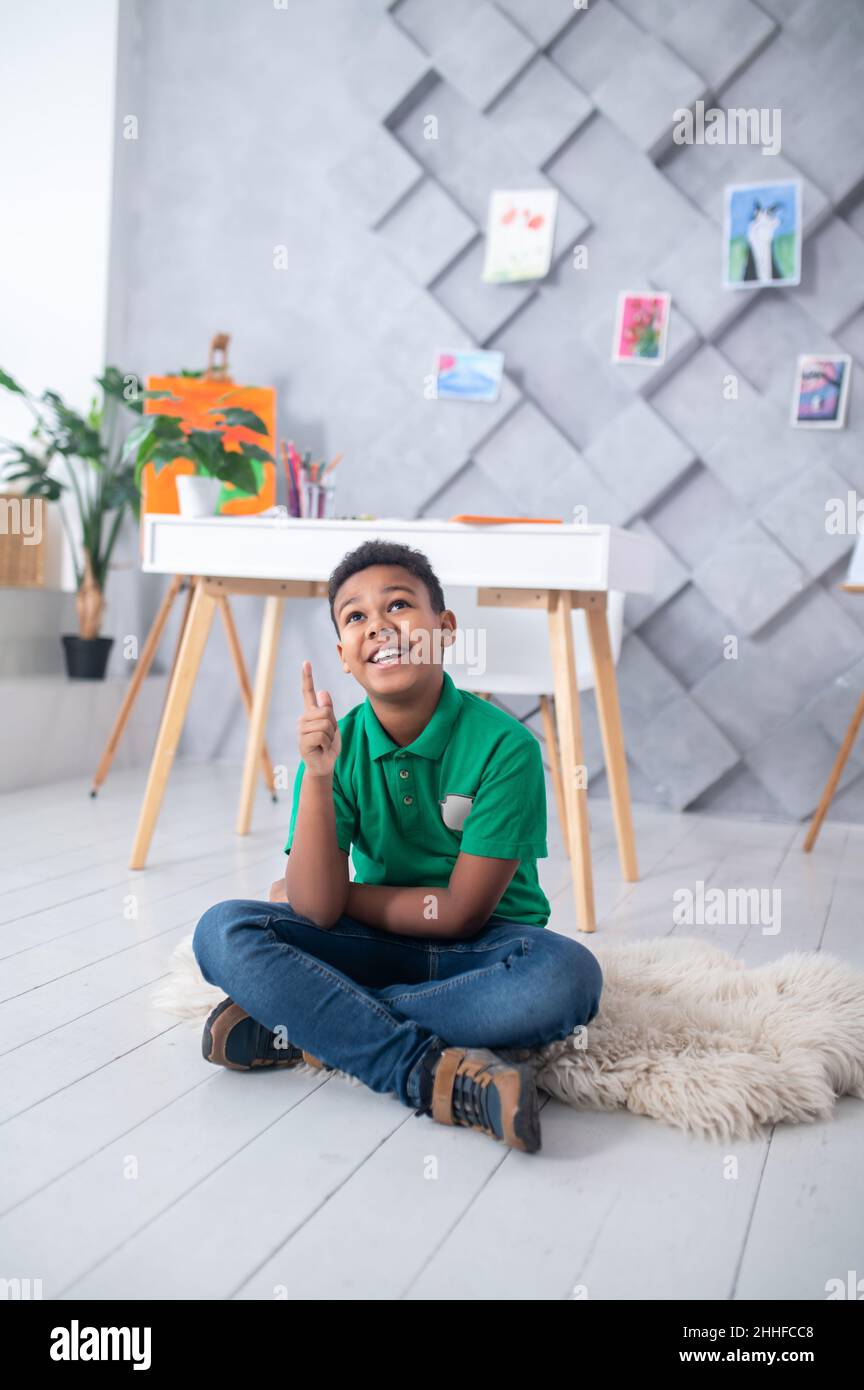 African boy sitting on floor hi-res stock photography and images - Alamy