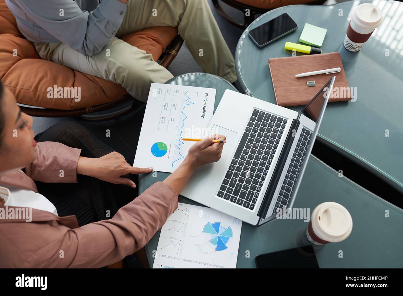 Business people talking about data in report with charts and diagrams ...