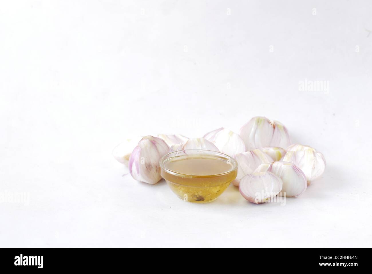 red inion oil in a container on table on white background Stock Photo ...