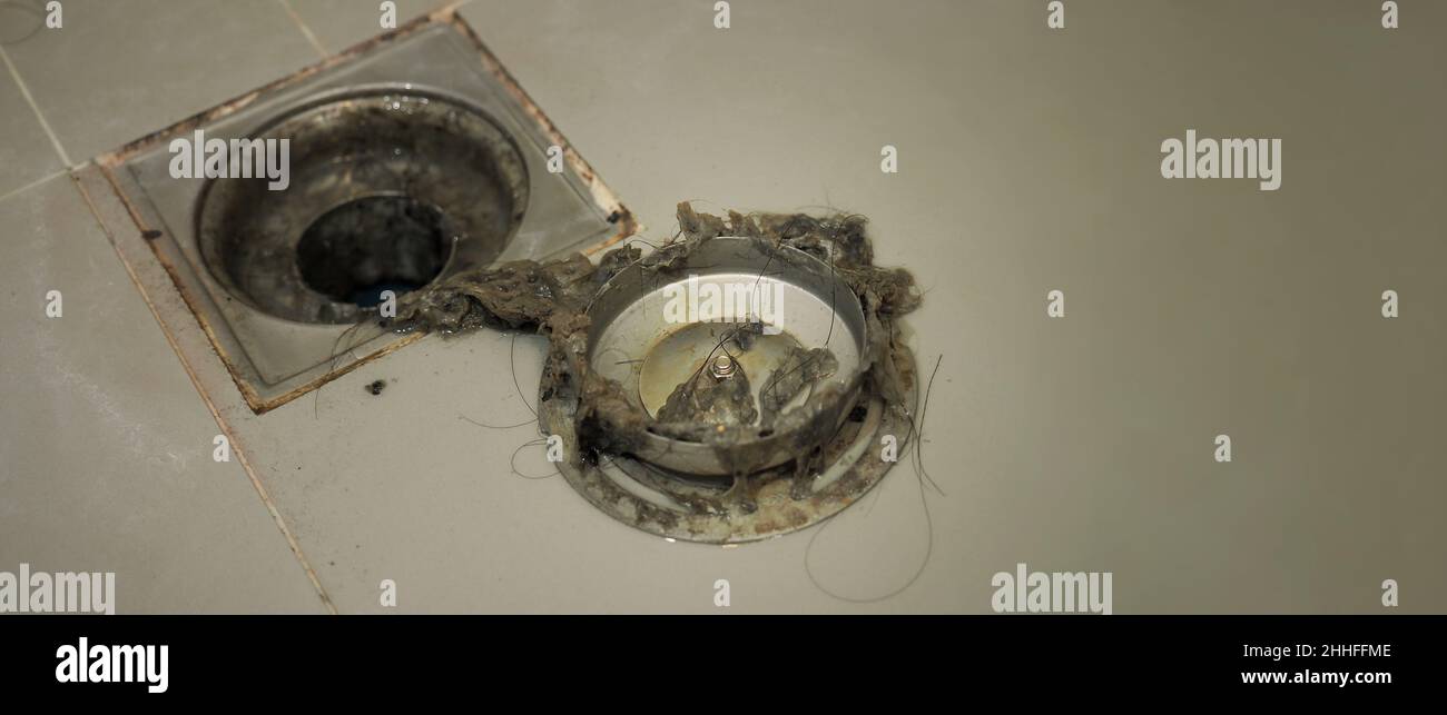 Drain cleaning. Clogged and dirty sewer pipes floor drain. Full of hair ...