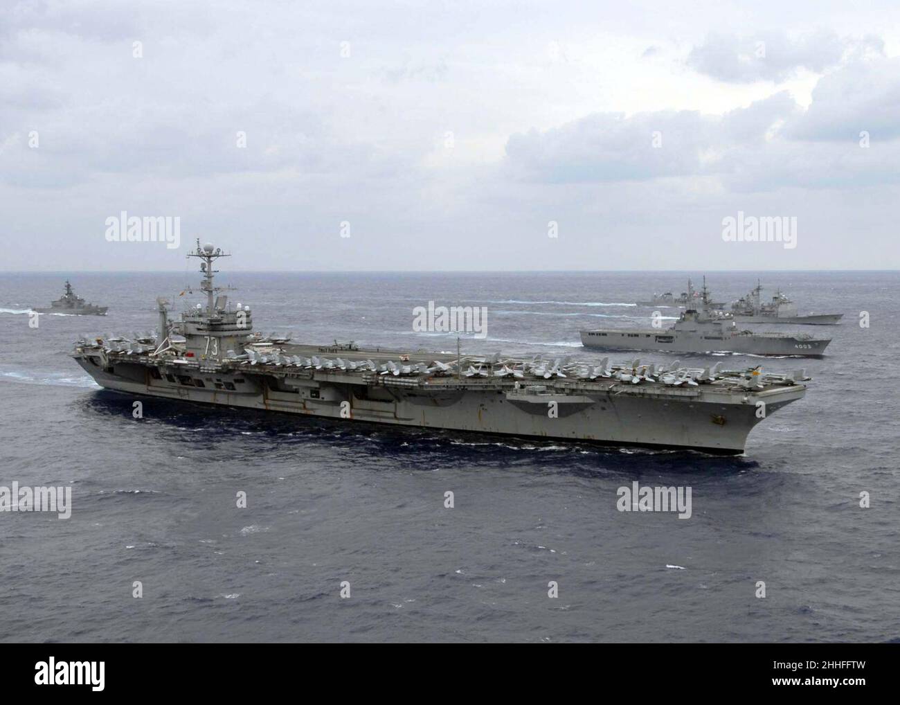 Starboard bow view of USS George Washington (CVN-73) in formation with ...