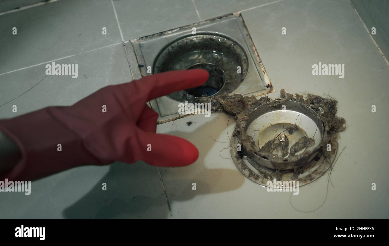 Drain cleaning. Clogged and dirty sewer pipes floor drain. Full of hair ...