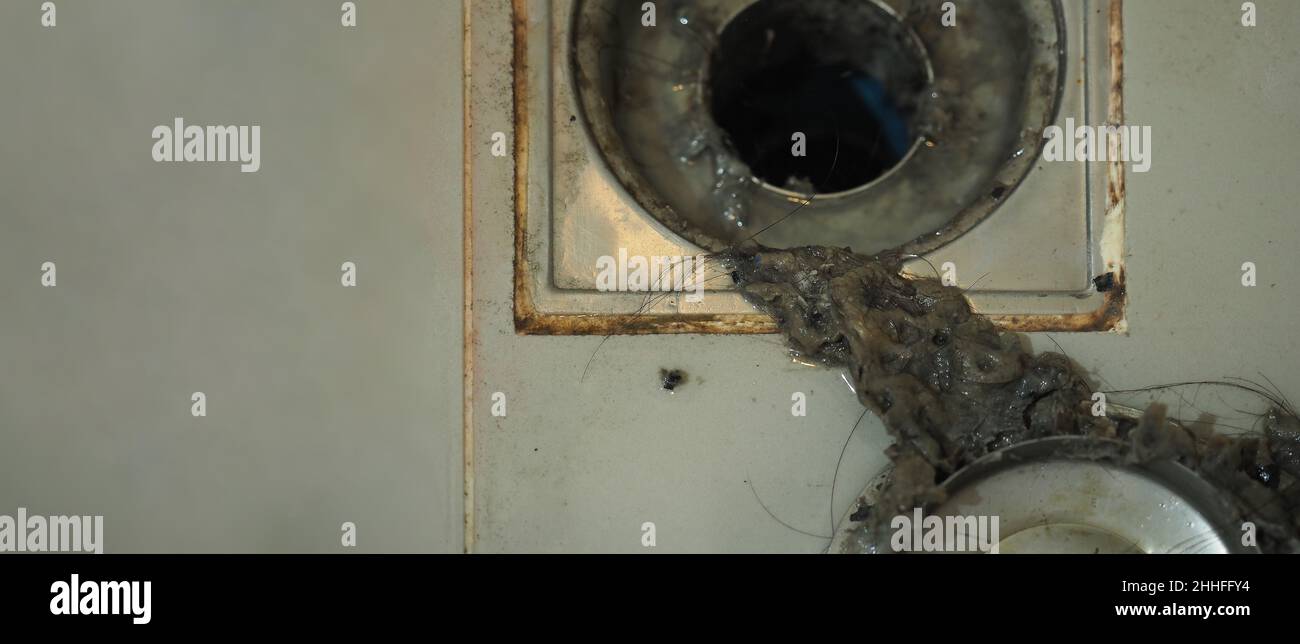 Drain cleaning. Clogged and dirty sewer pipes floor drain. Full of hair ...