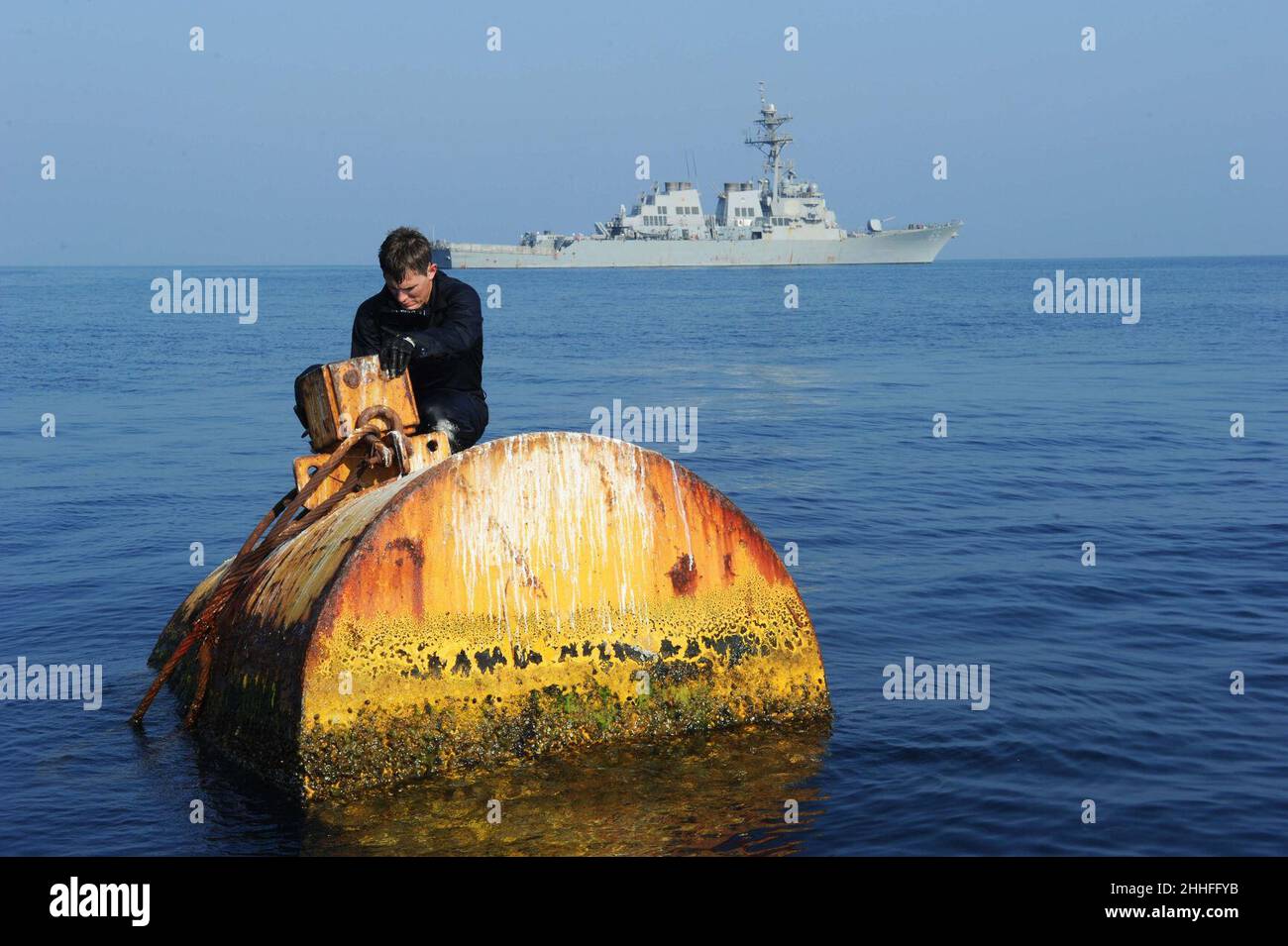 Starboard side view of USS Benfold (DDG-65) behind Navy Diver examining ...